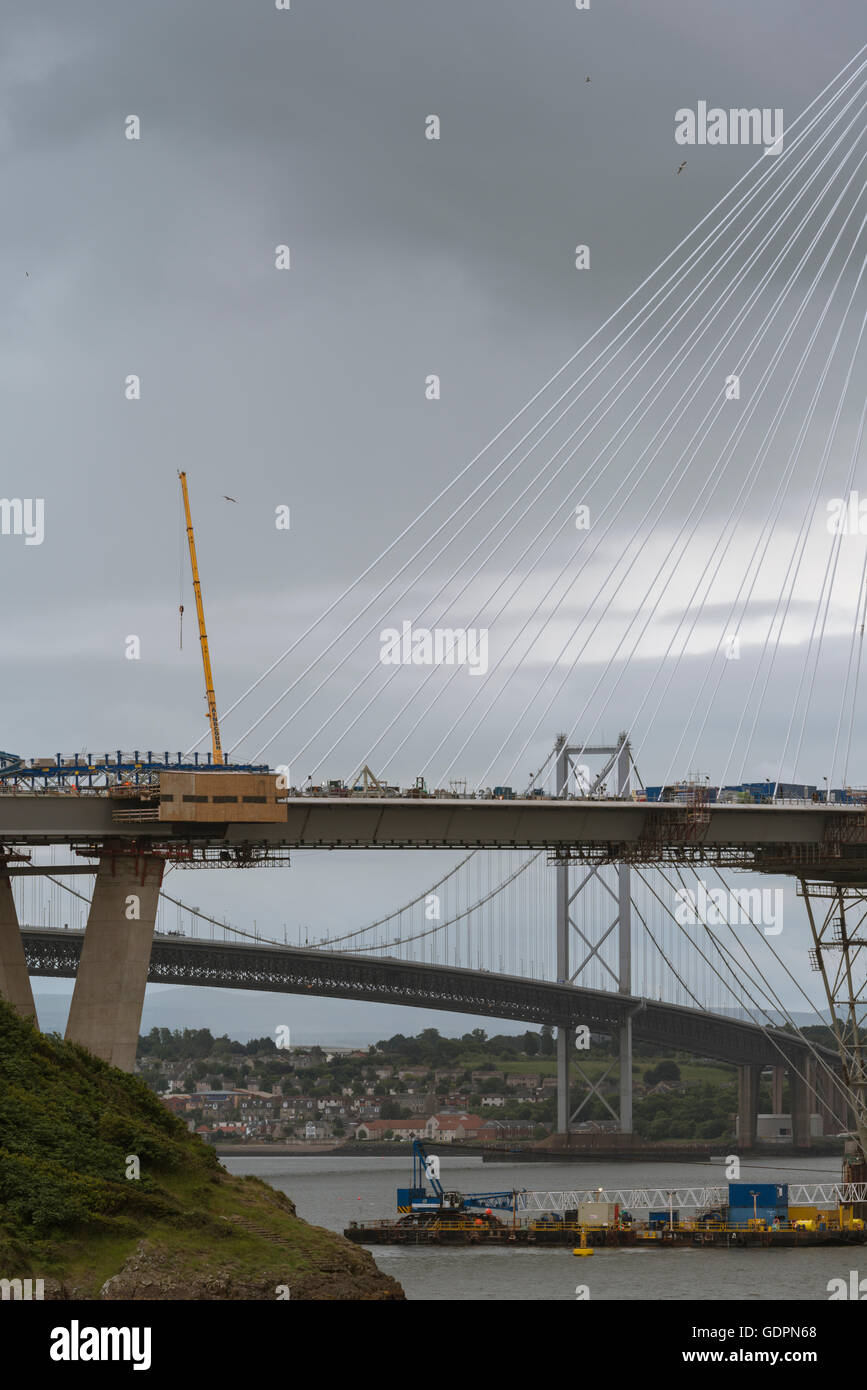 Forth Road Bridge behind cables and deck of Queensferry Crossing over ...