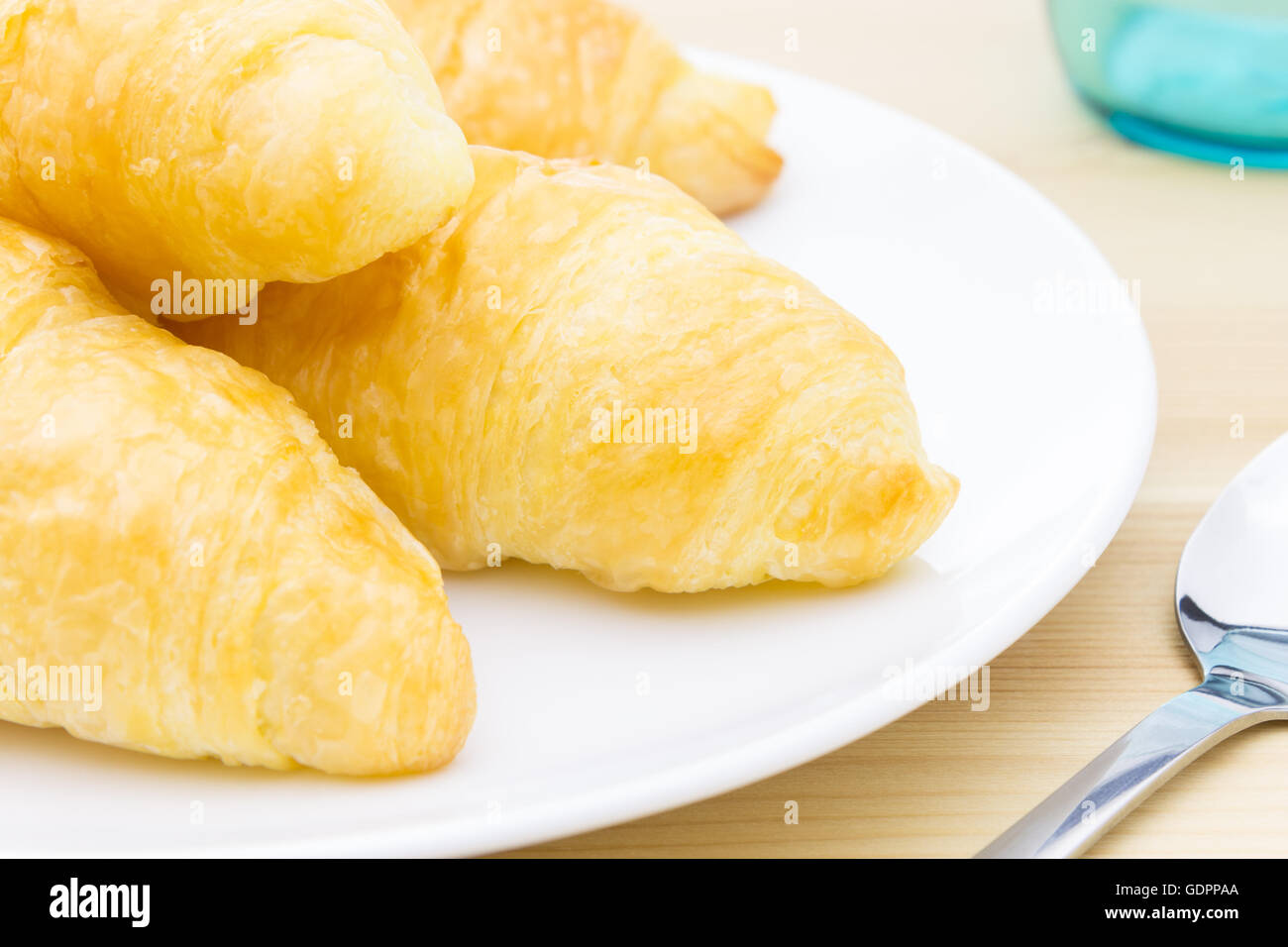 Croissant or bread or bakery on white dish on wood table and glass and ...