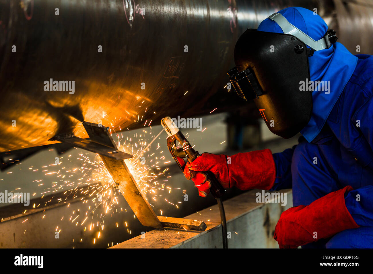 Welder in factory welding metal pipes Stock Photo - Alamy