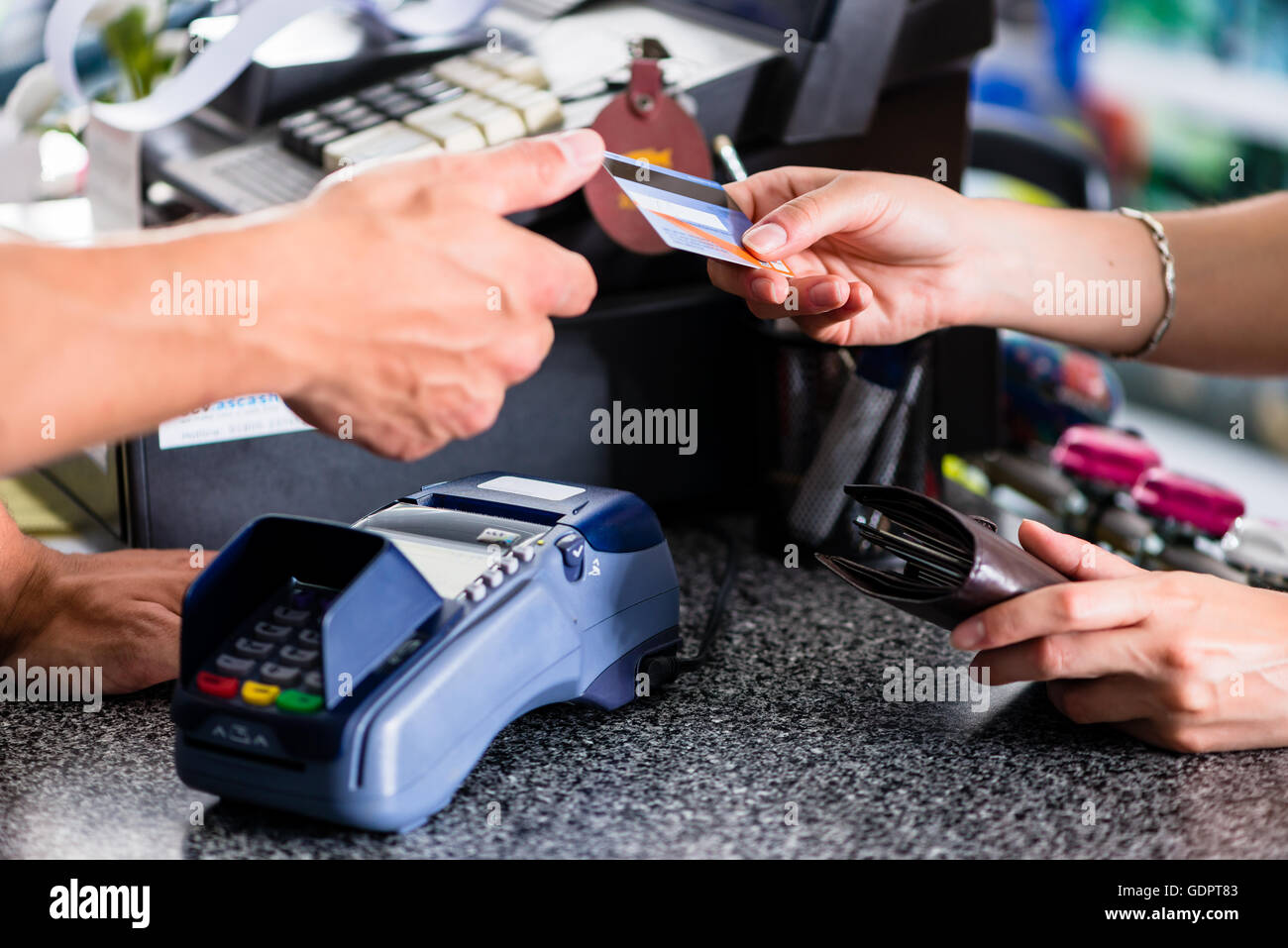 Credit card payment at terminal in shop Stock Photo - Alamy