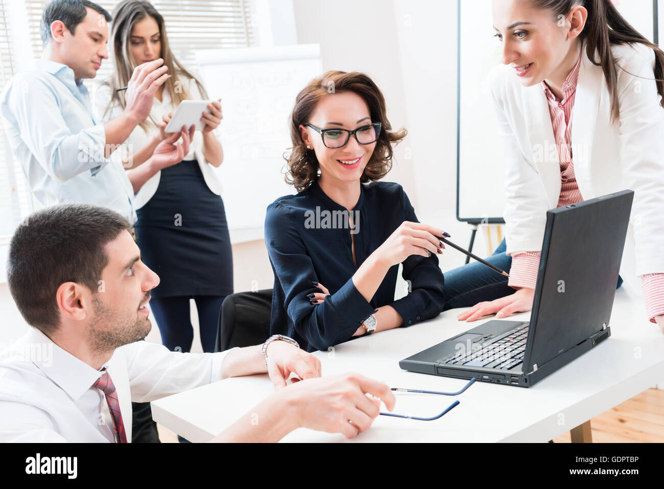 Team giving business report to boss in office meeting Stock Photo - Alamy