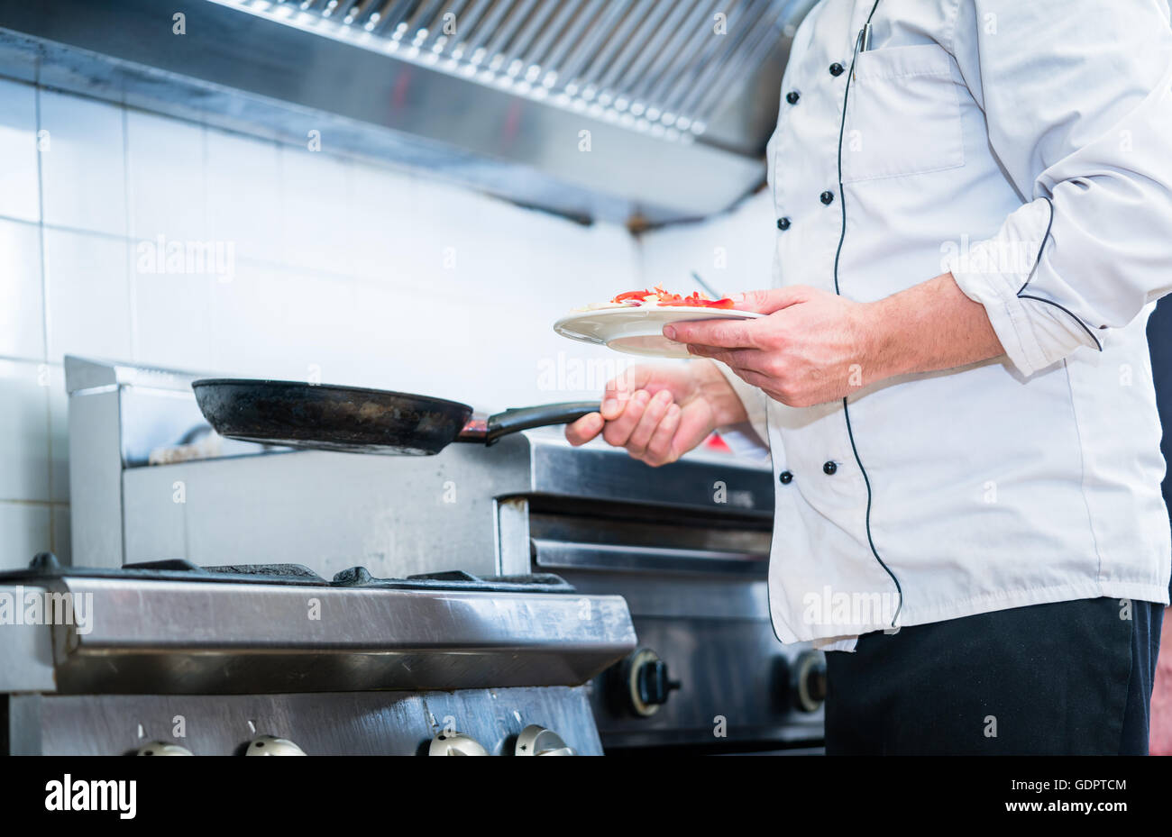 Chef with pan in restaurant kitchen Stock Photo - Alamy