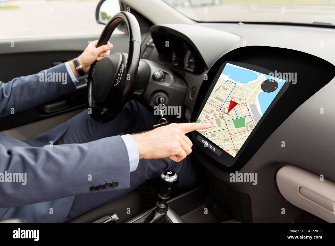 close up of man driving car with gps navigator map Stock Photo - Alamy