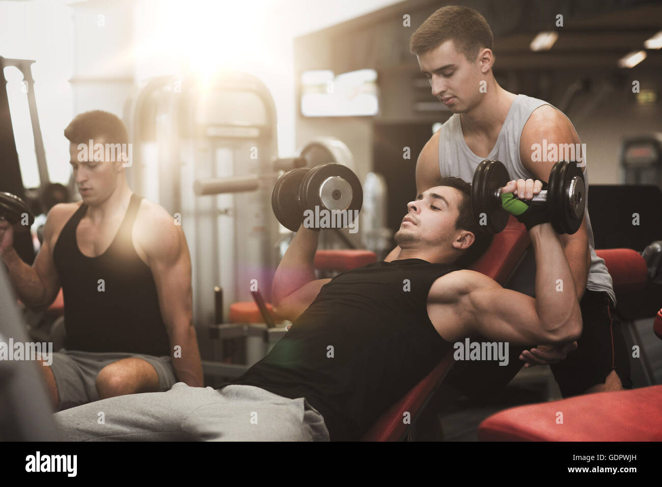 group of men with dumbbells in gym Stock Photo - Alamy