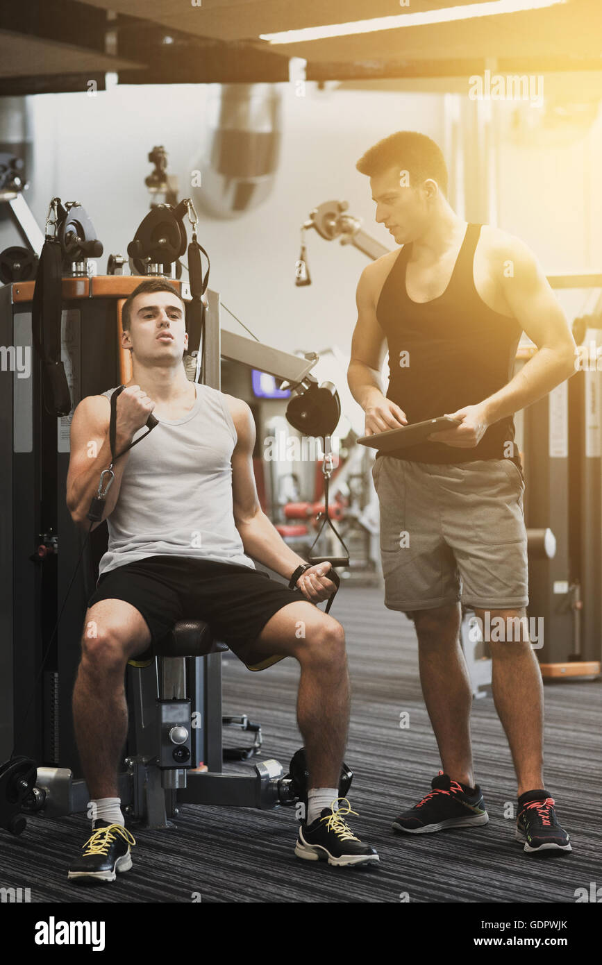 man exercising on gym machine Stock Photo - Alamy