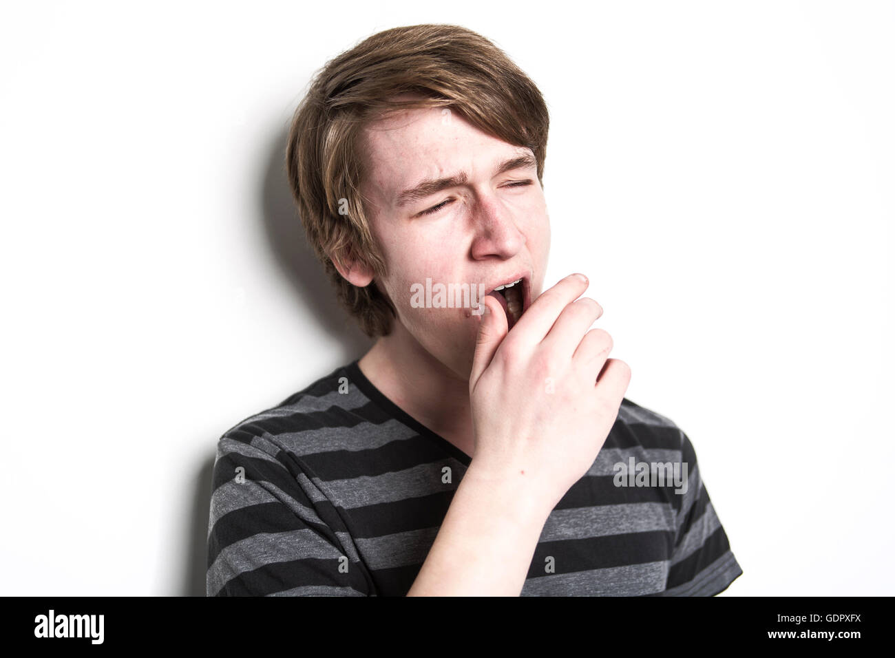 Teenage boy yawning hi-res stock photography and images - Alamy
