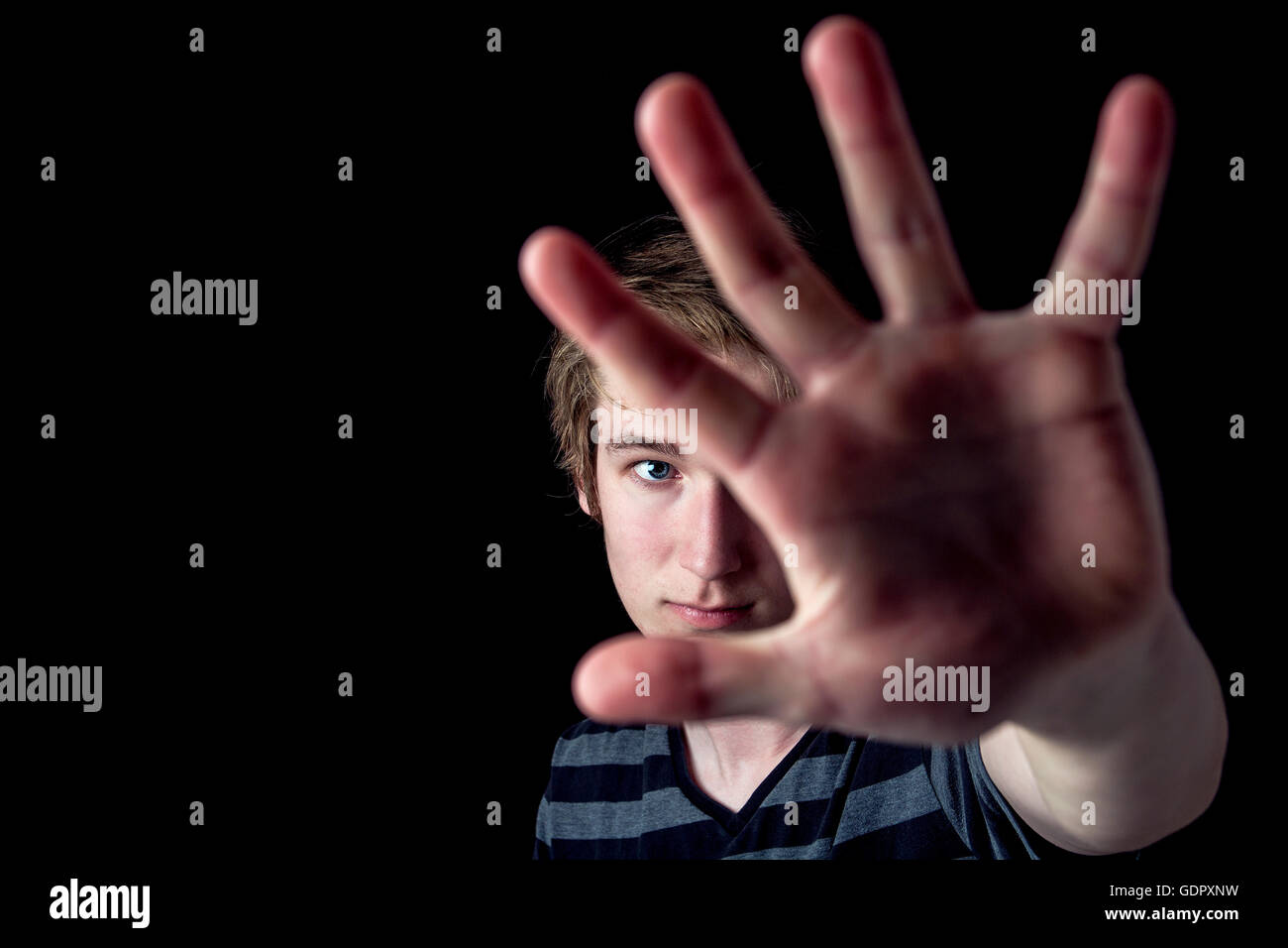 image of a boy with his hand extended signaling to stop Stock Photo - Alamy