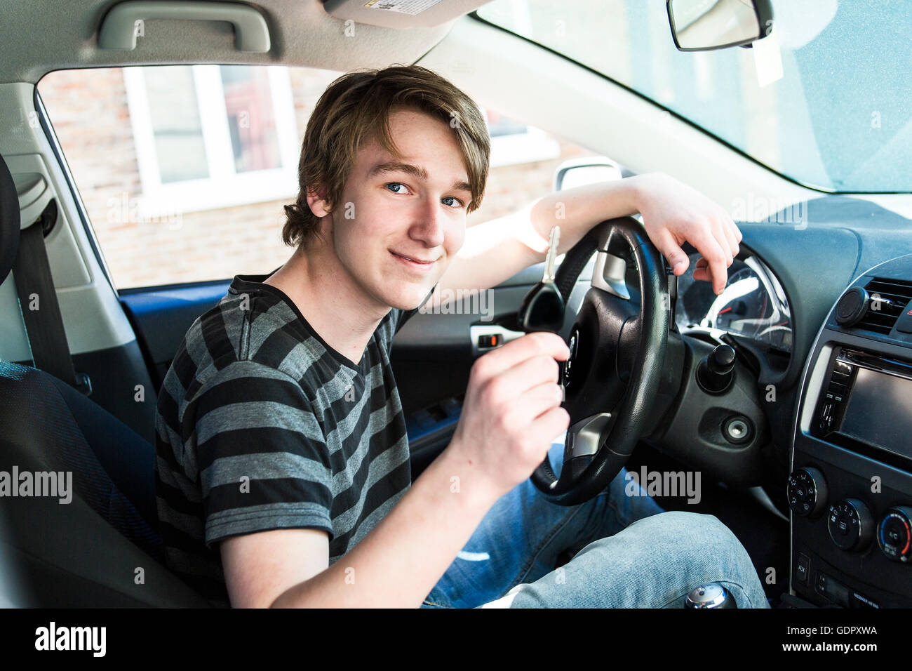 Teenage boy and new driver behind wheel of his car Stock Photo - Alamy