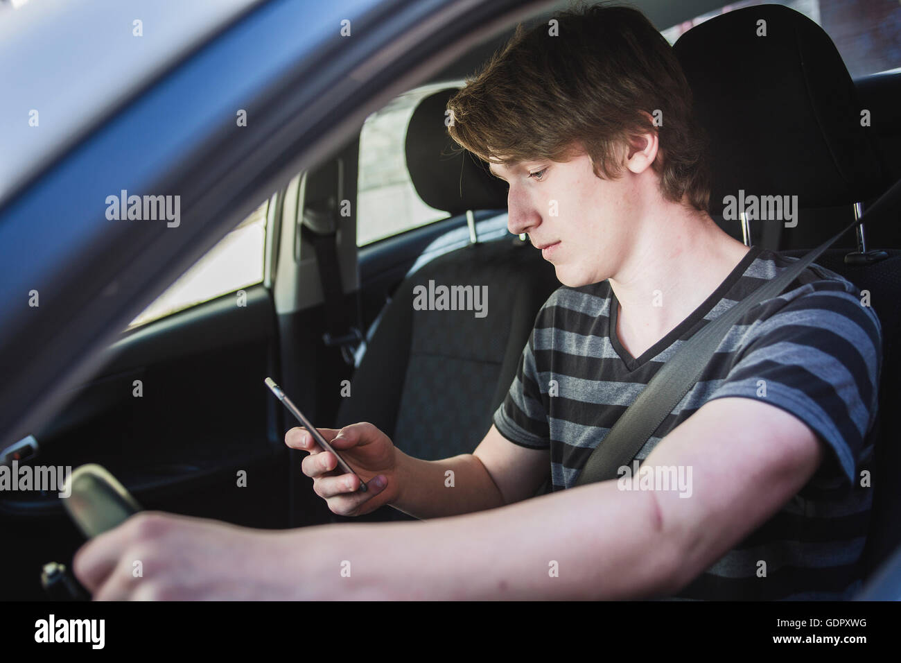 Teenage boy and new driver behind wheel of his car Stock Photo - Alamy
