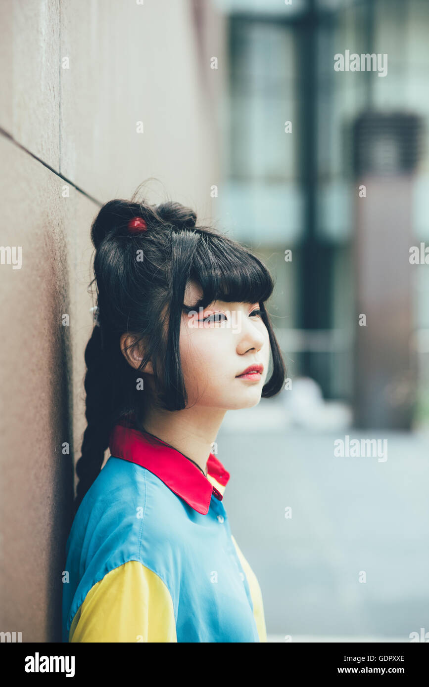 Half length portrait of young beautiful asian millennial woman outdoor ...