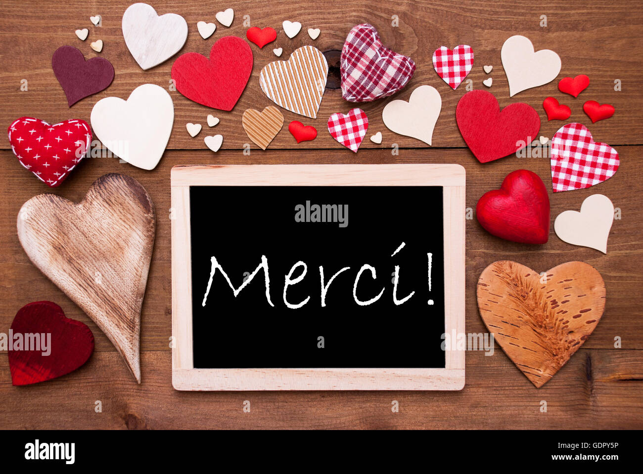 One Chalkbord, Many Red Hearts, Merci Means Thank You Stock Photo - Alamy