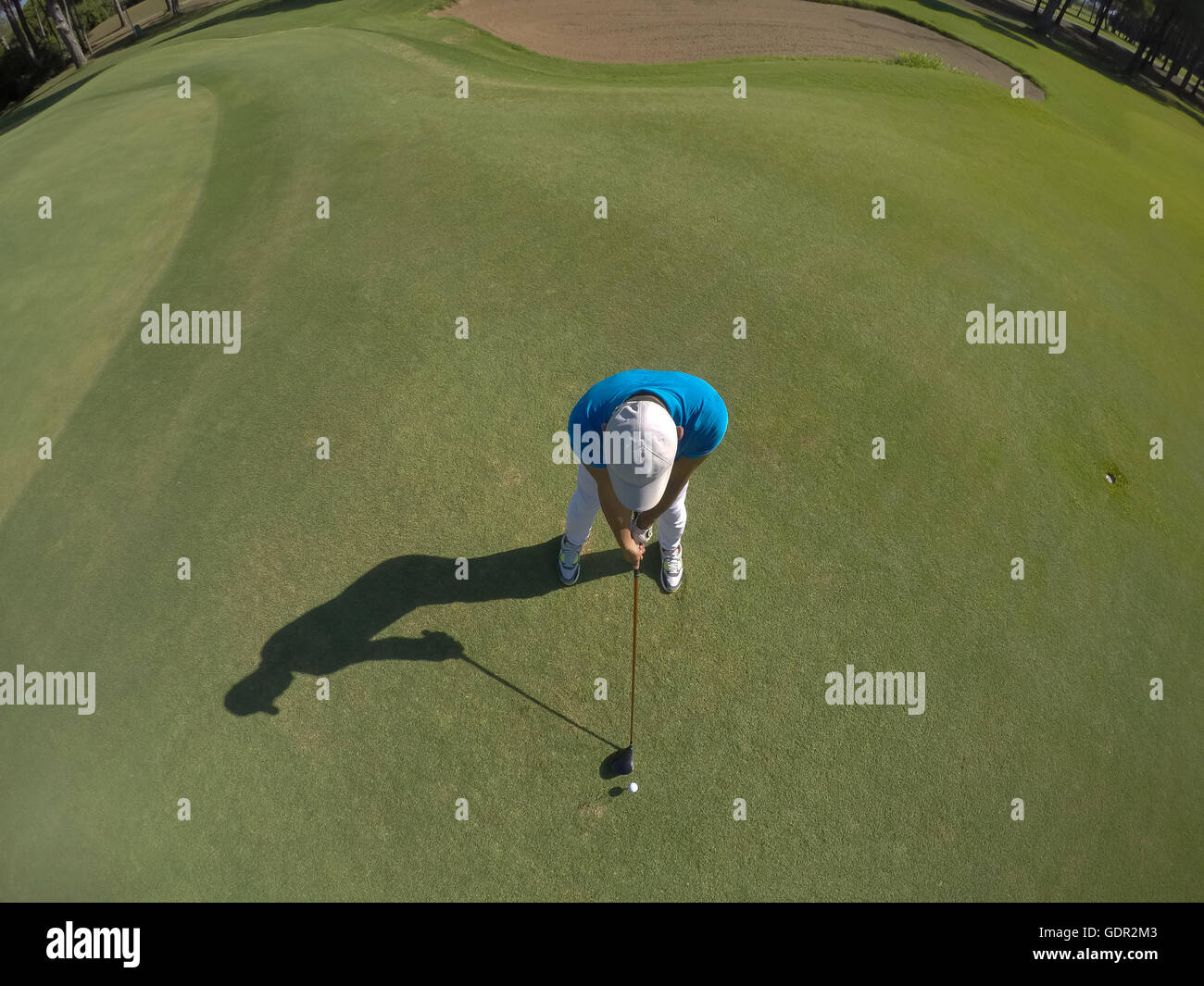top view of golf player hitting shot with club on course at beautiful ...