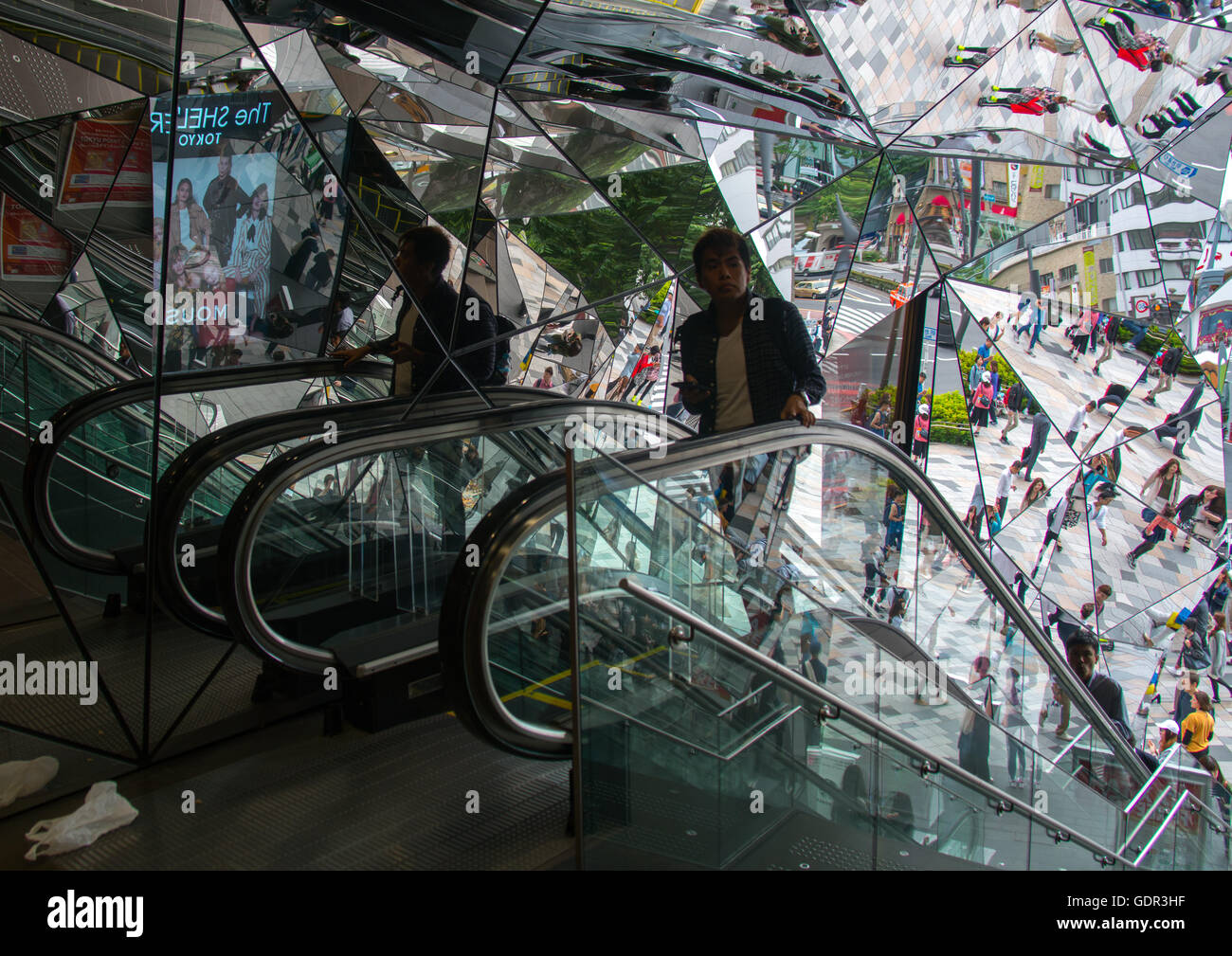 Walking people reflected on glass in tokyu plaza i, Kanto region, Tokyo ...