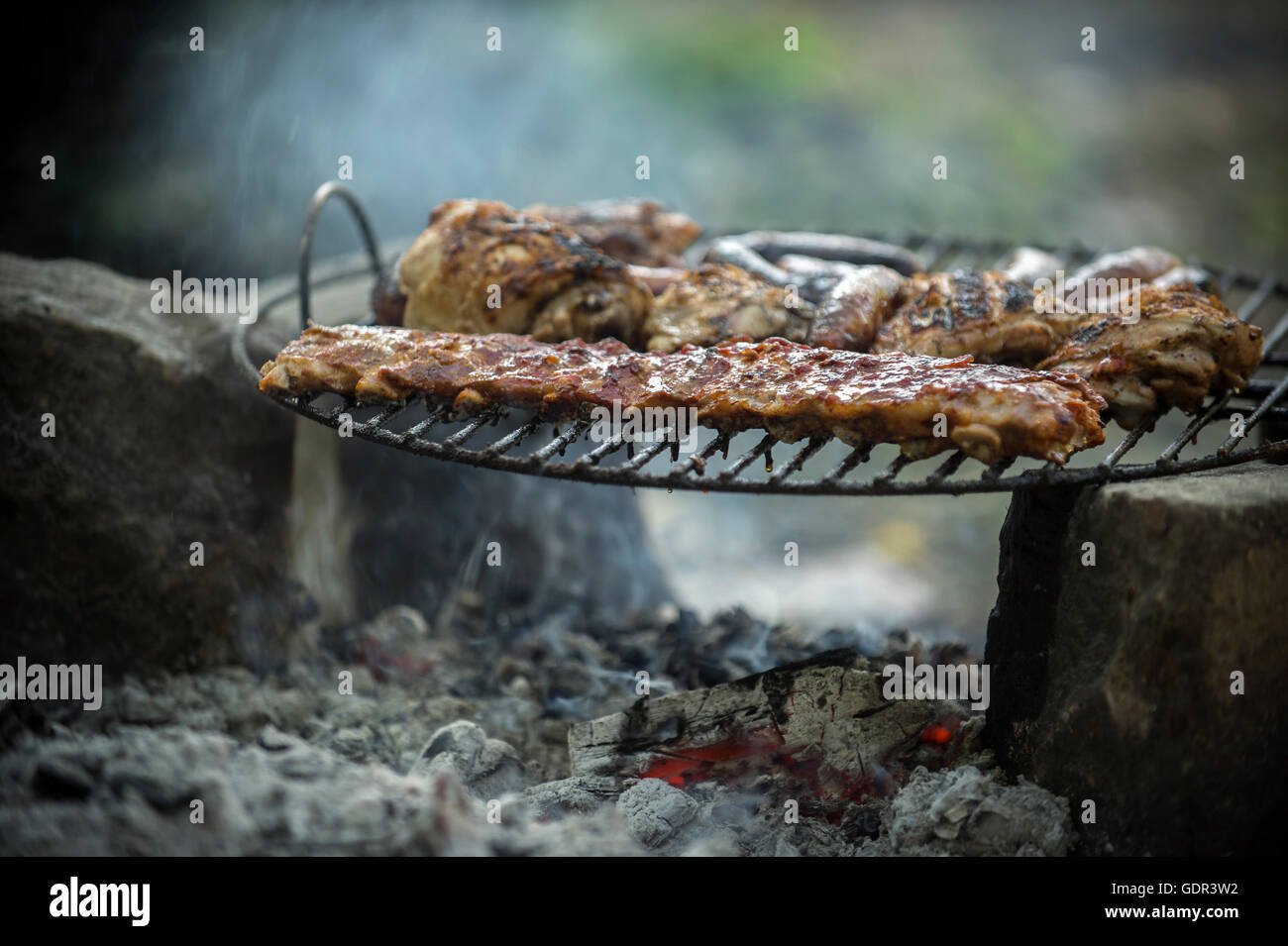 BBQ over a fire Stock Photo - Alamy