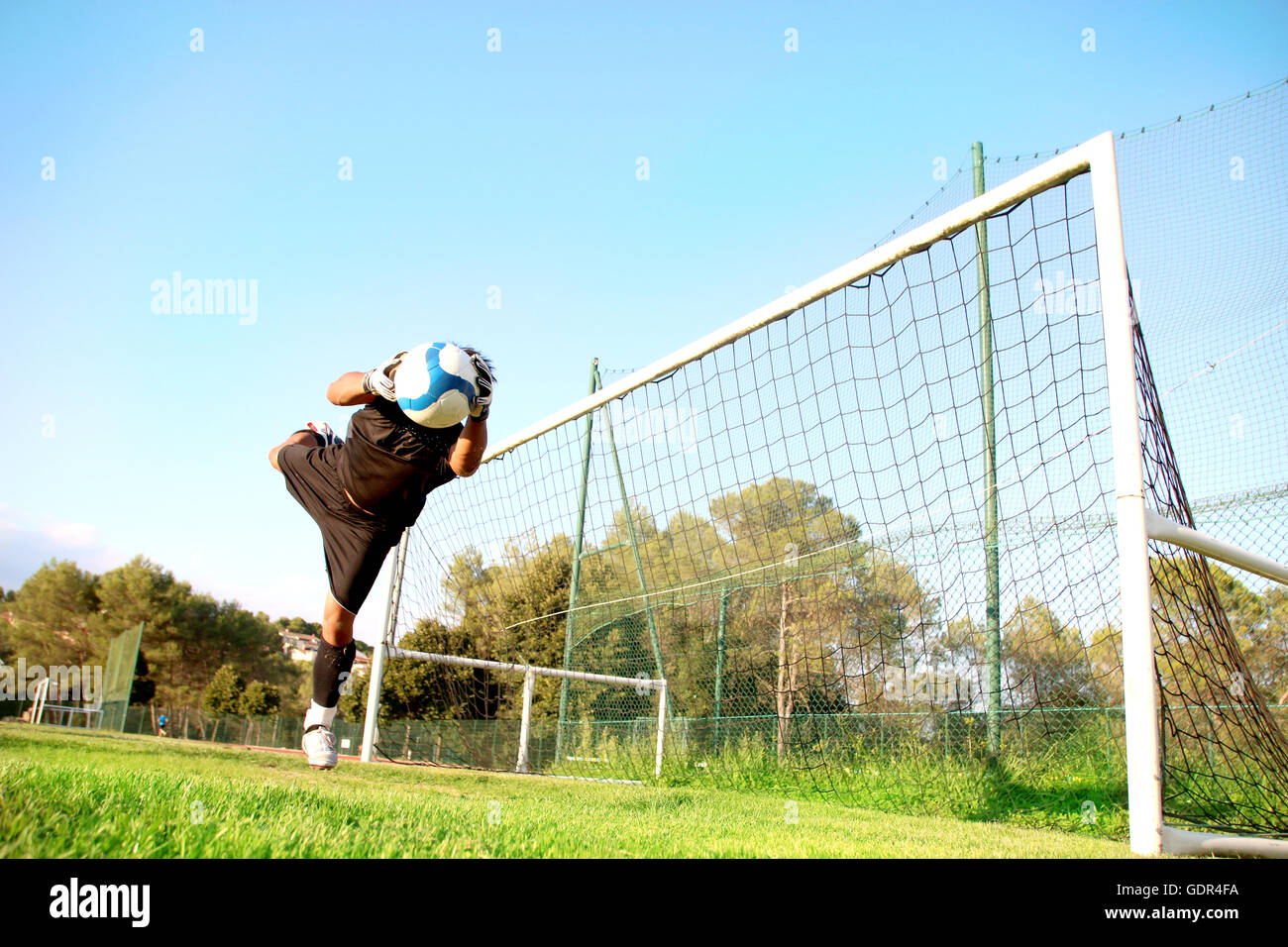 Goalkeeper stopping a ball Stock Photo - Alamy