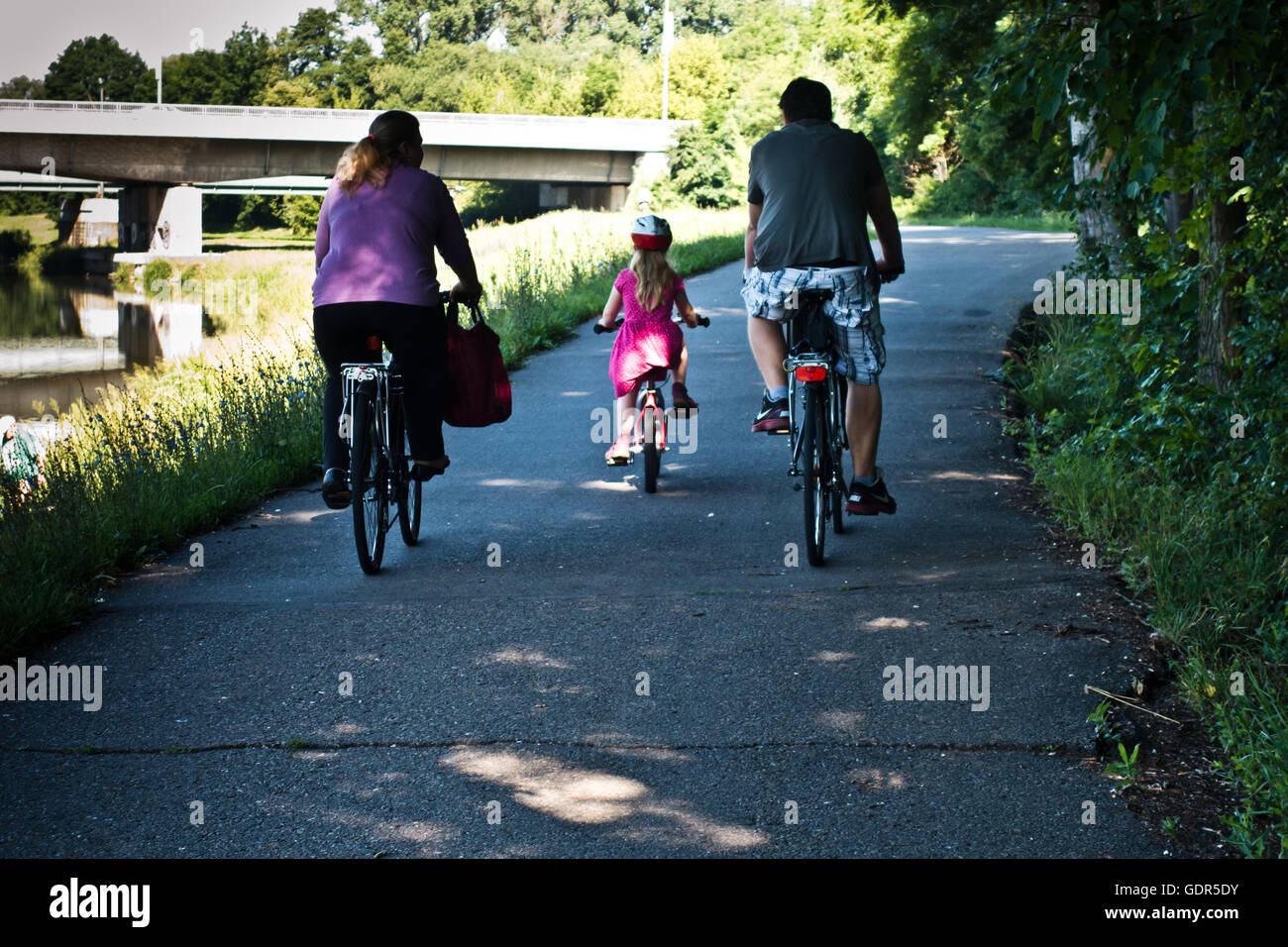 family riding in bicycle Stock Photo - Alamy