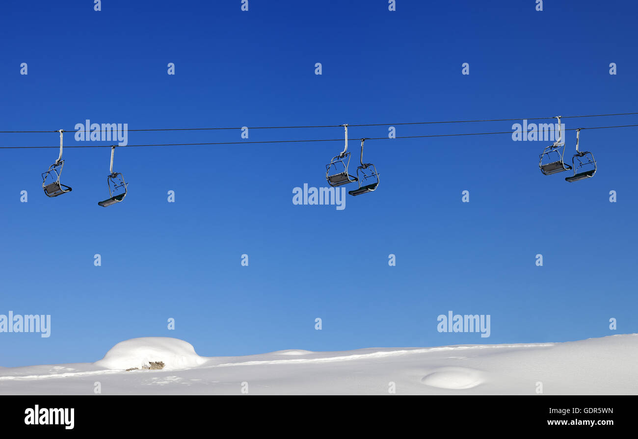 Chair-lift and blue clear sky at sun day. Greater Caucasus, Mount ...