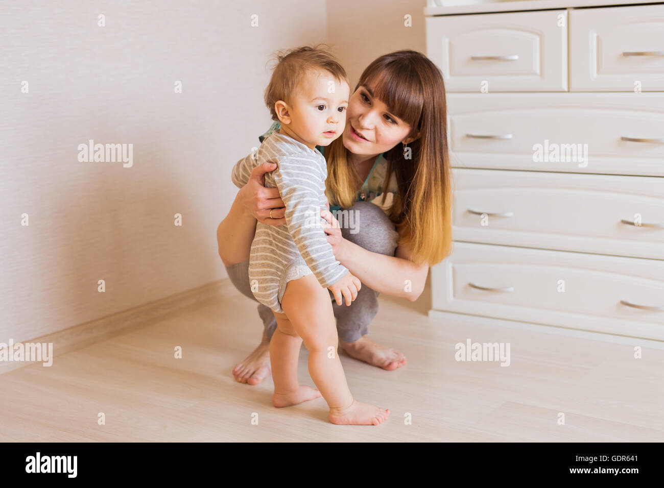 Mother and baby legs. First steps Stock Photo - Alamy