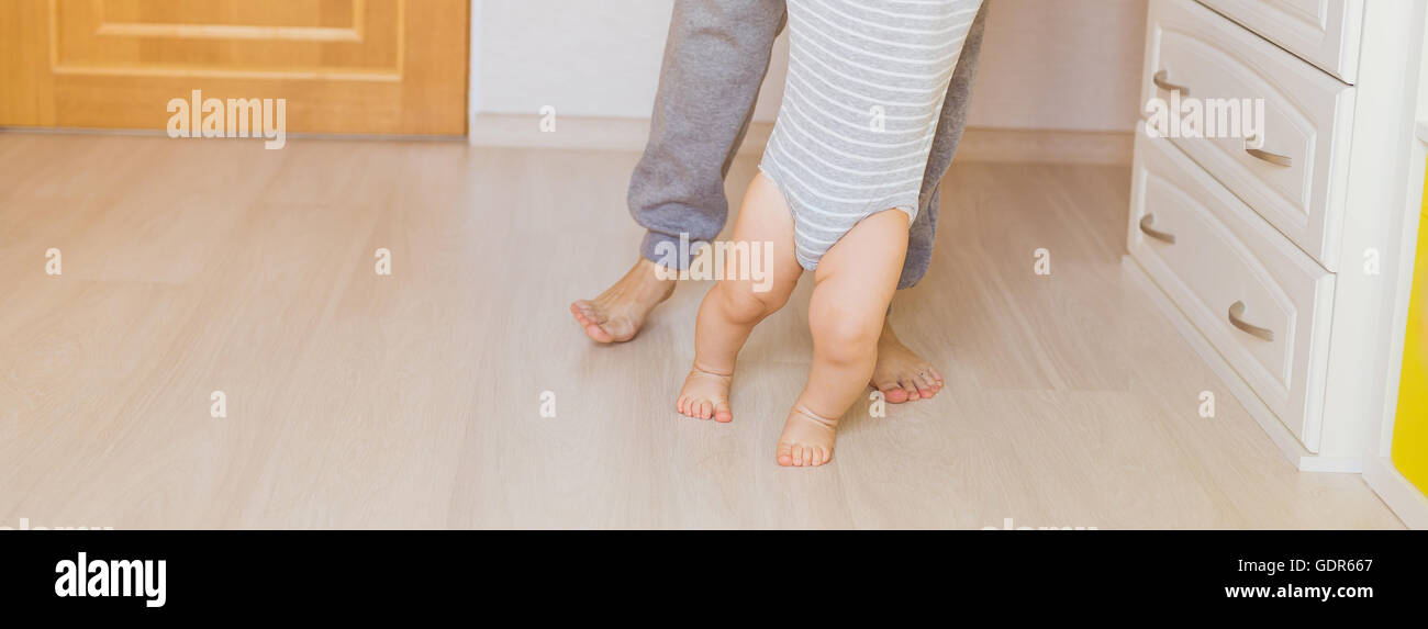 Portrait of mother and baby legs. First steps Stock Photo - Alamy
