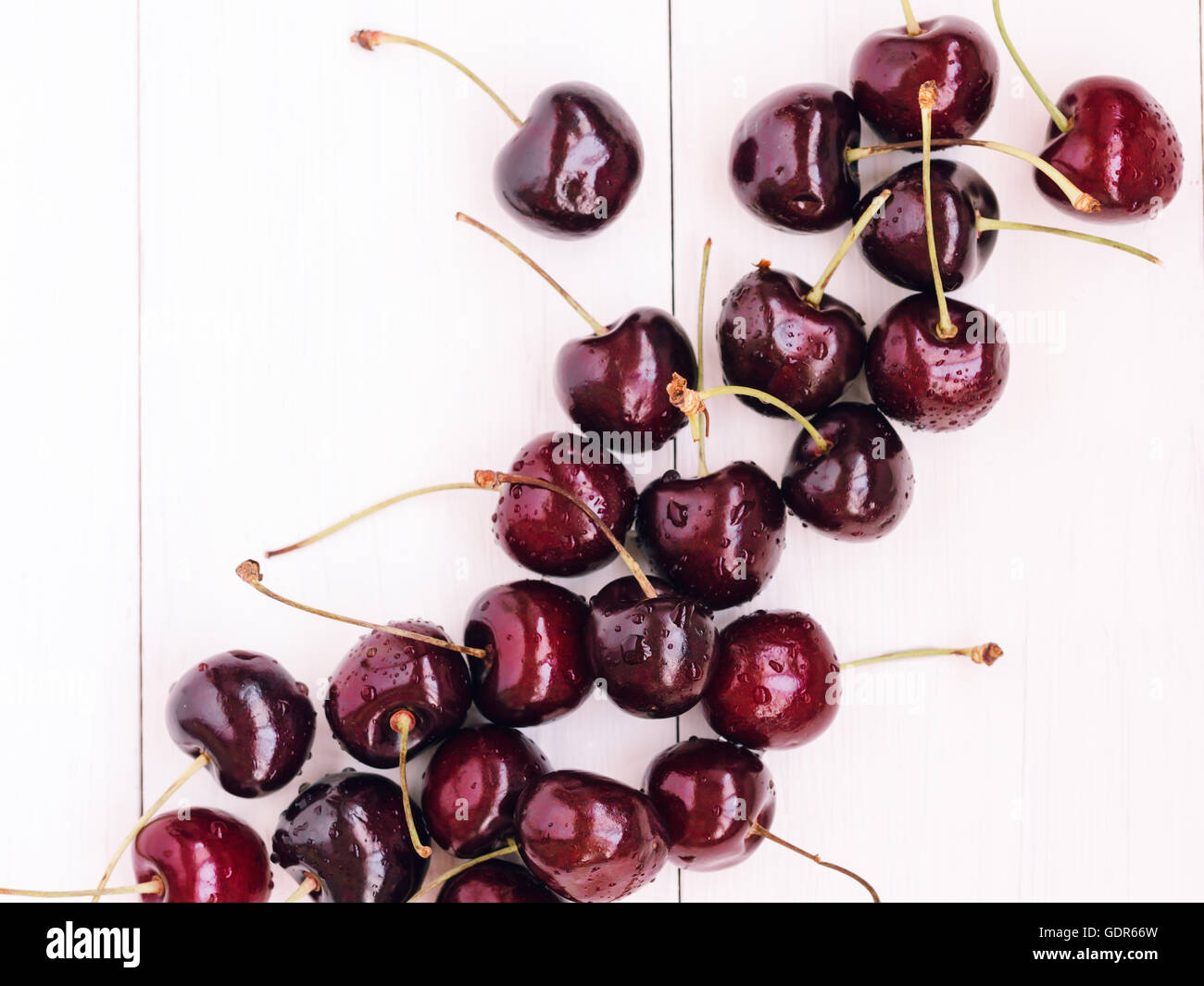 Ripe cherry on white wooden table. Top view Stock Photo - Alamy
