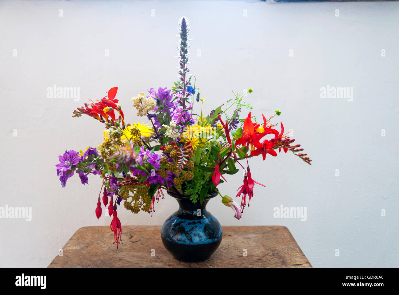Wild flowers of County Donegal, Ireland. In vase on wooden table Stock ...