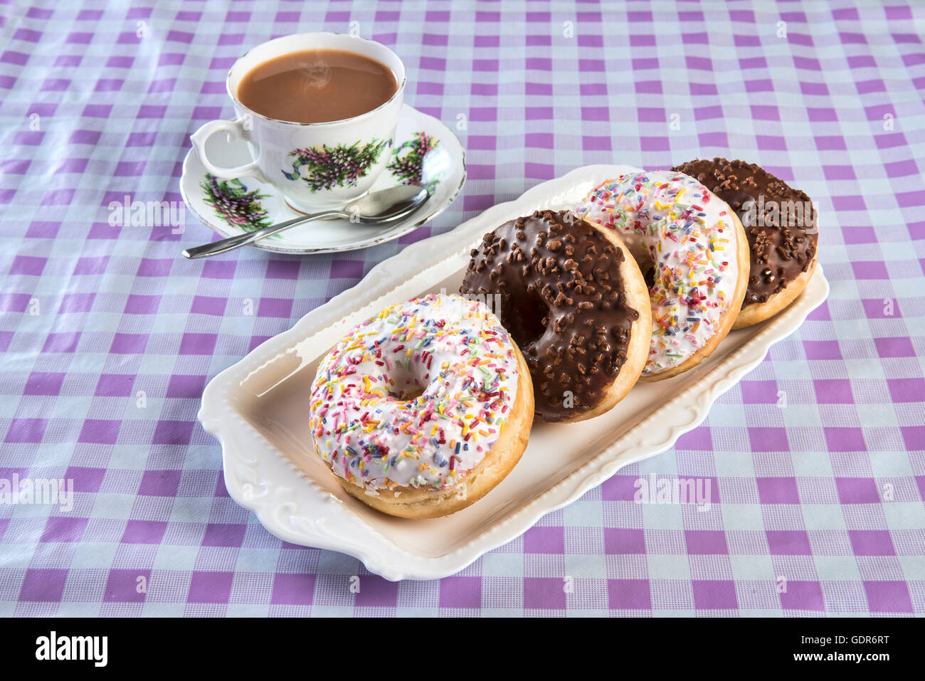 A selection of tasty donuts and a cup of tea Stock Photo - Alamy