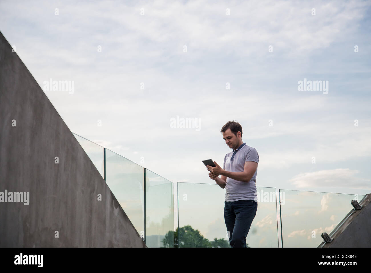 Young man searching information using an tablet computer Stock Photo ...