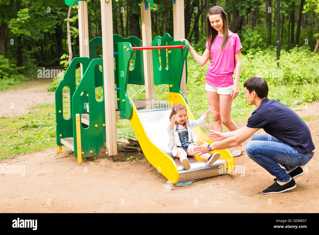 Happy family playing together at outdoor park Stock Photo - Alamy