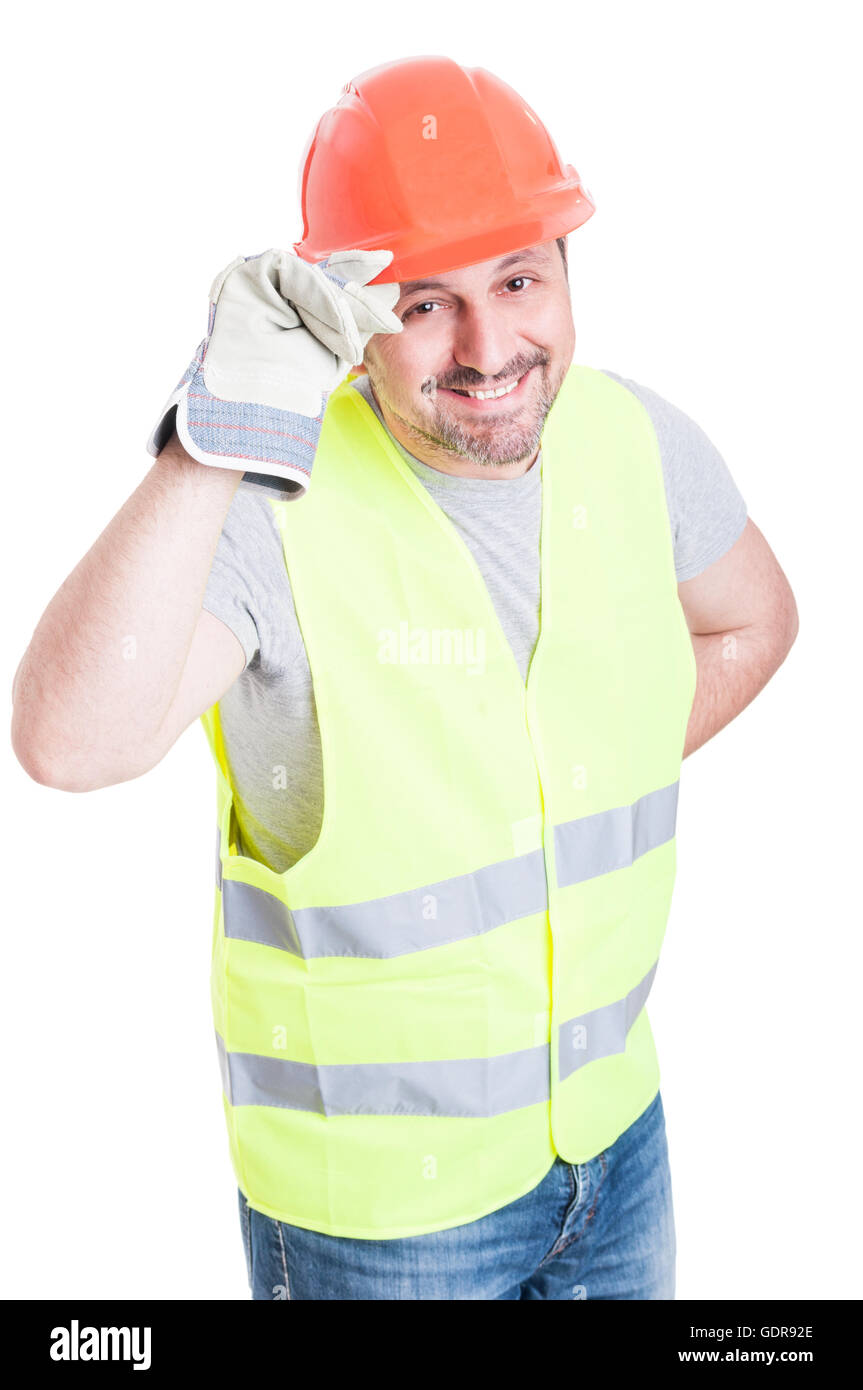 Attractive builder man smiling and holding helmet acting polite ...