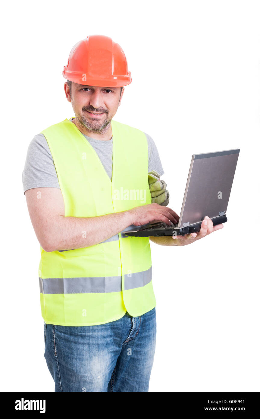 Friendly attractive engineer holding and working on laptop as ...