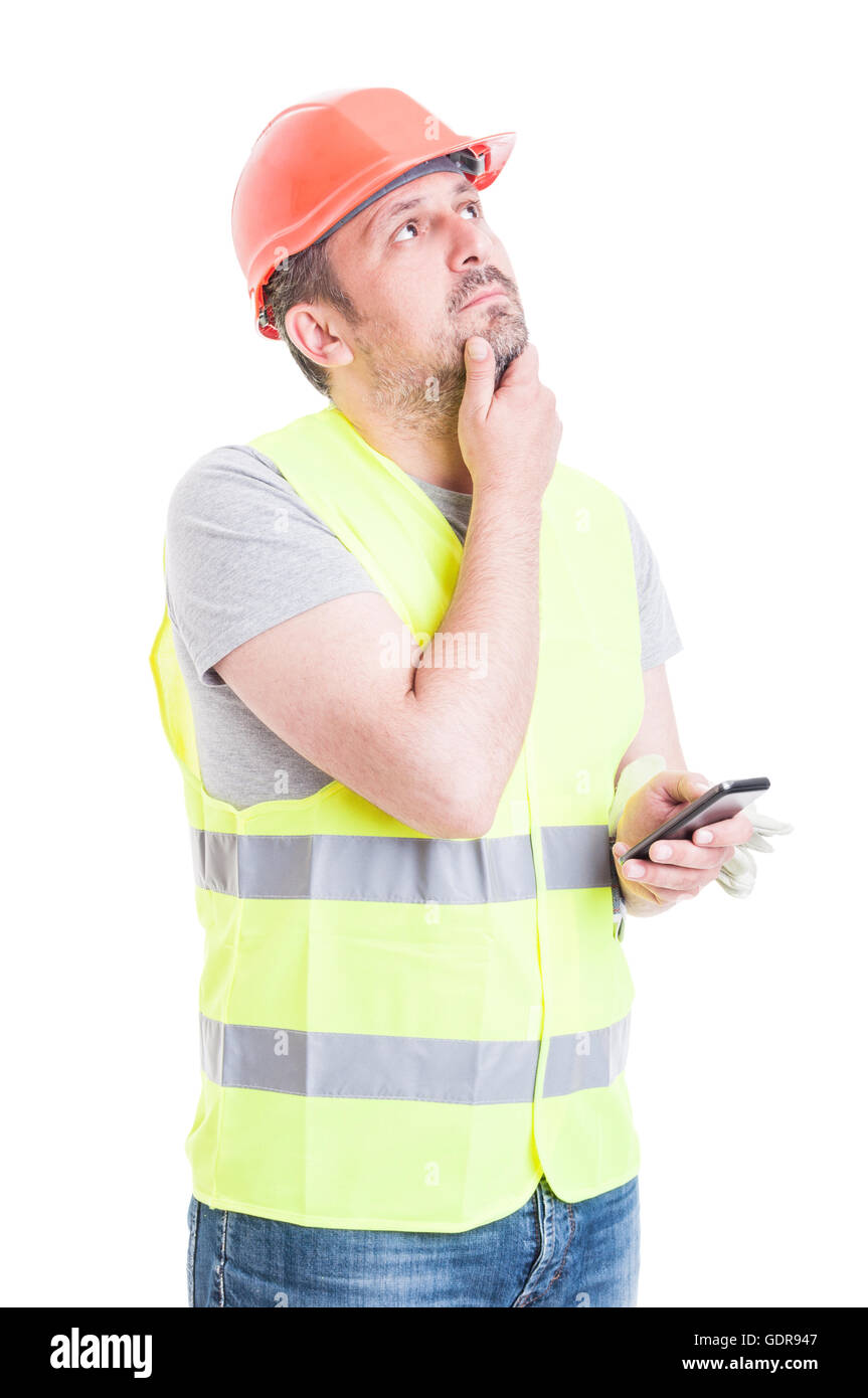 Constructor male with mobile phone in hand looking worriend and ...