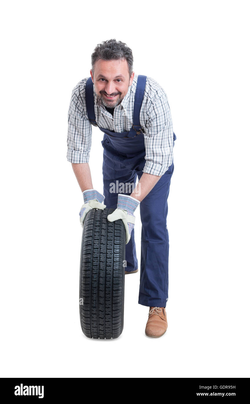 Handsome mechanic in workshop changing car wheel as repair and ...