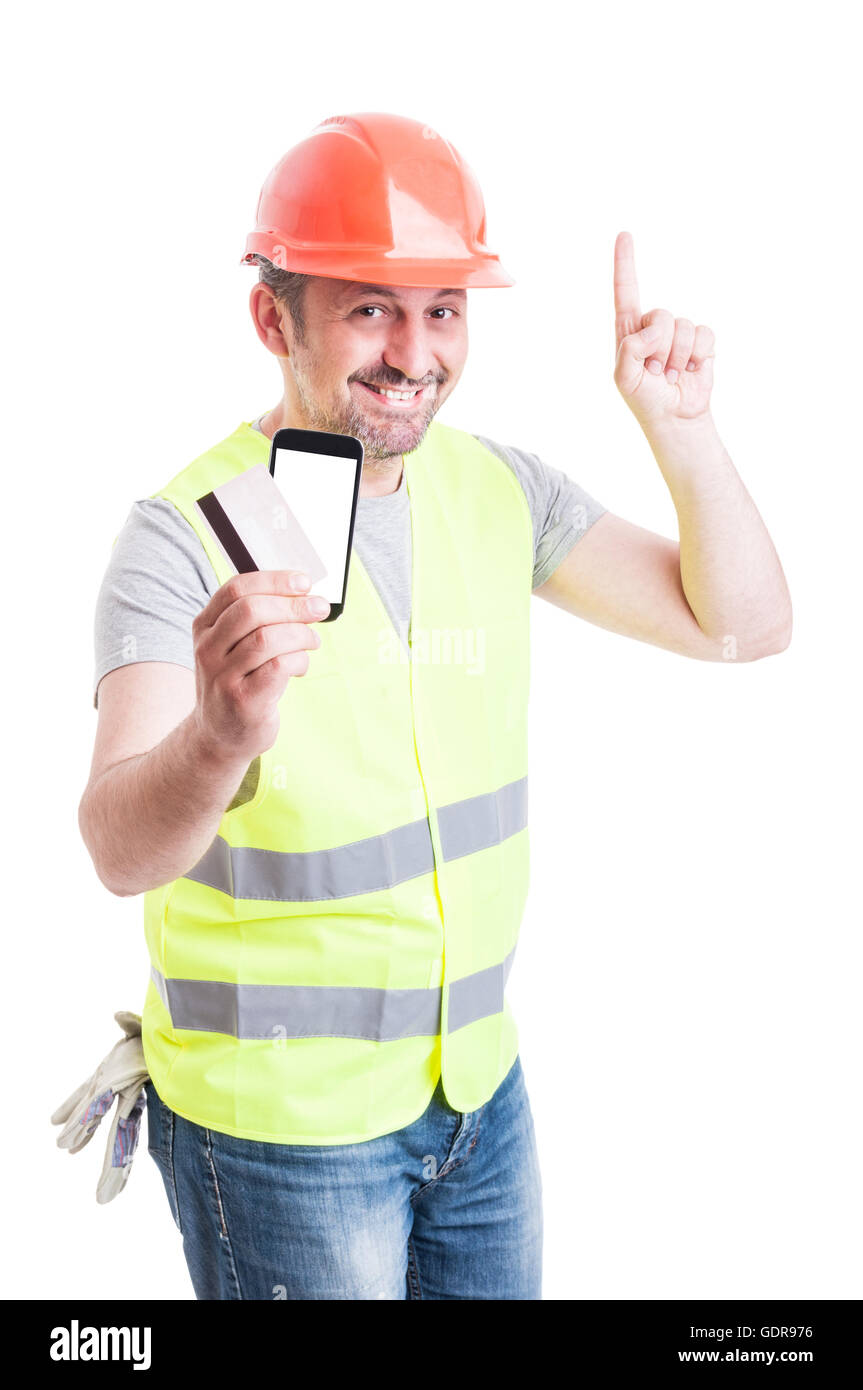 Attractive builder with debit card and phone with blank screen pointing ...