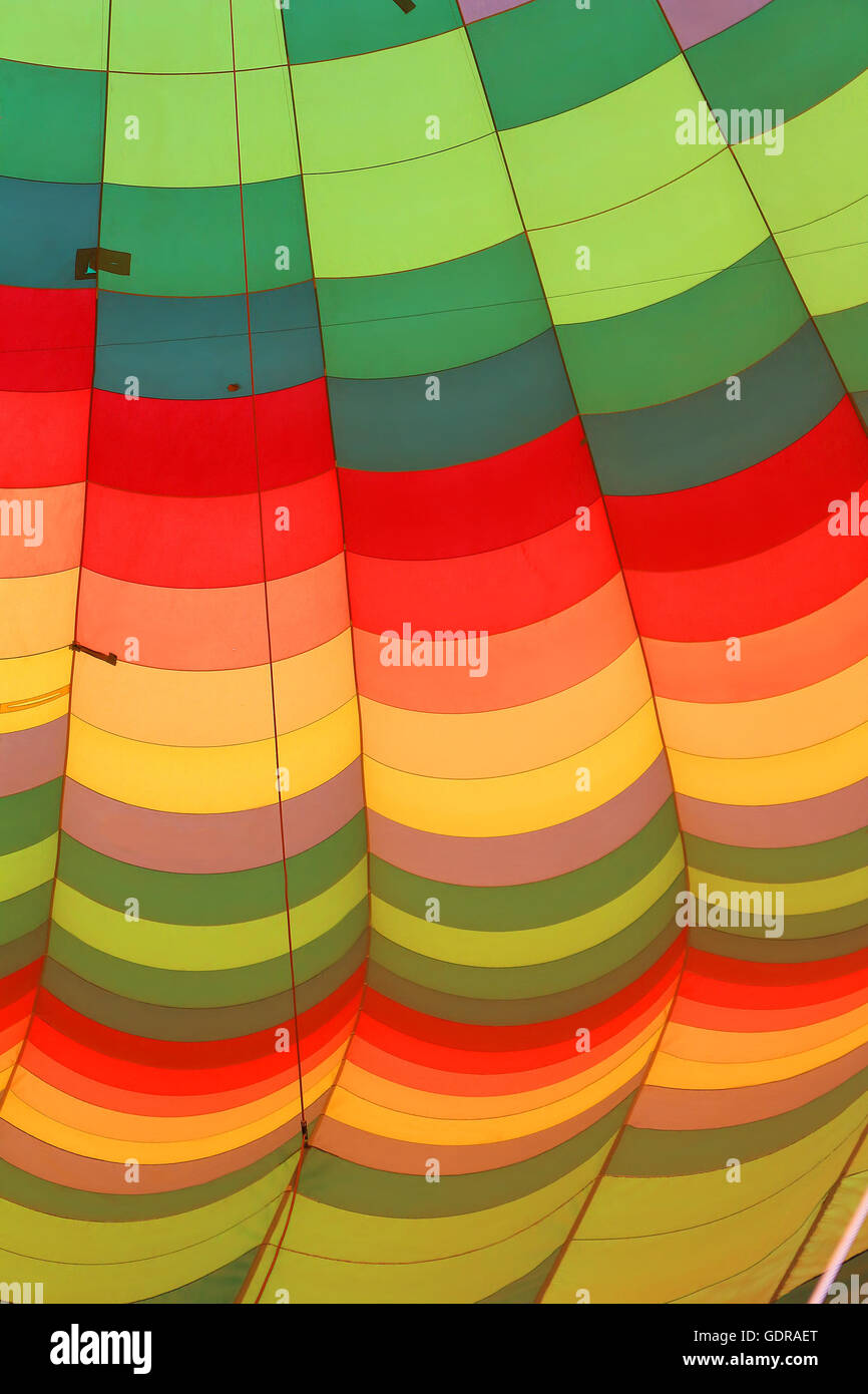 close up of the different colors of a hot air balloon being inflated or ...
