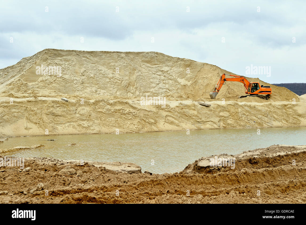 Working digger in a quarry produces sand Stock Photo - Alamy
