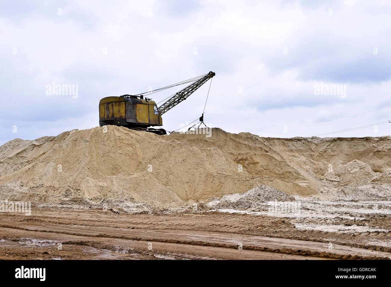 Working digger in a quarry produces sand. Working digger in a quarry ...