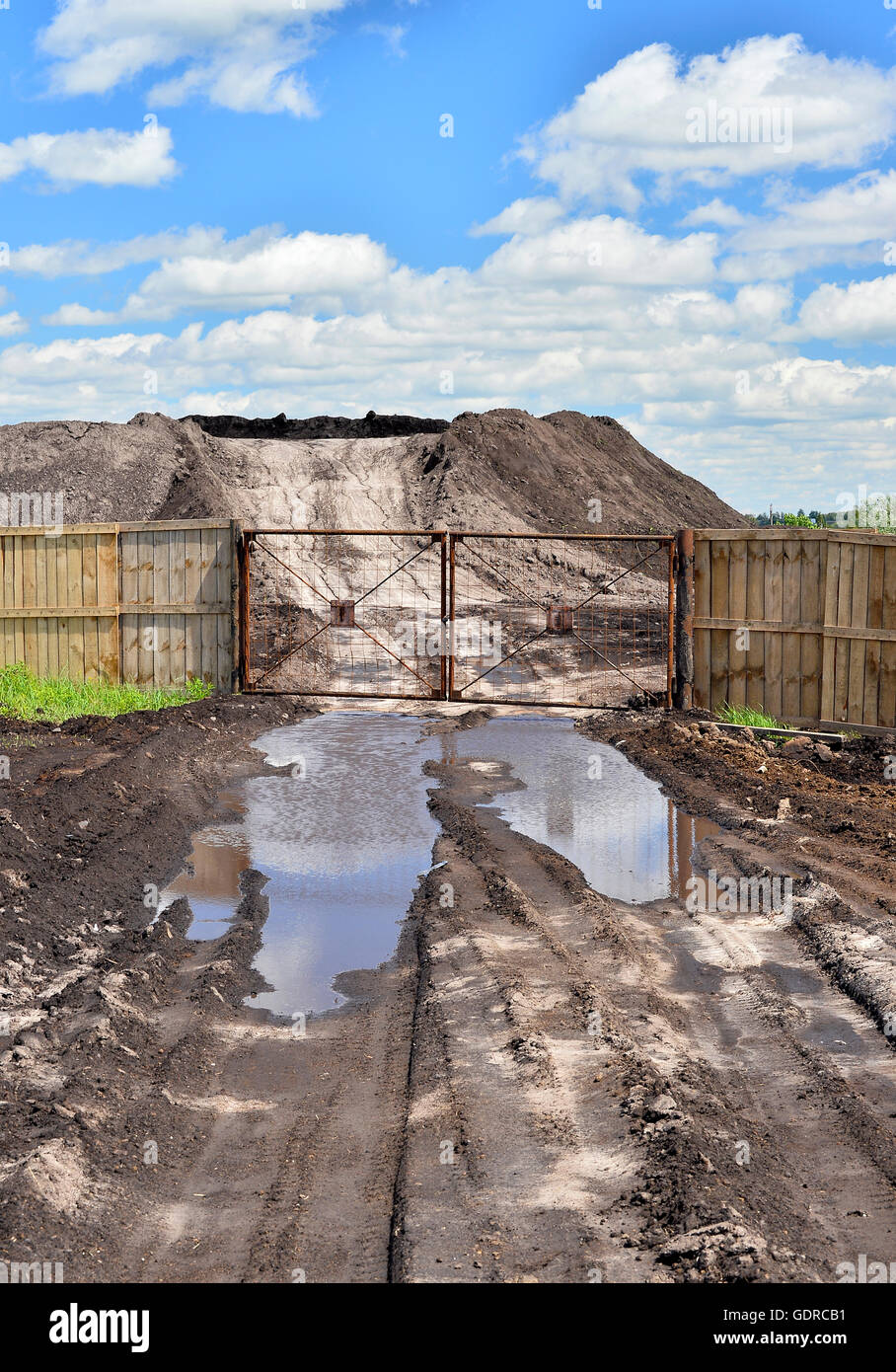 Dirt road, a pool and a lot of stored in the open air ground for a ...
