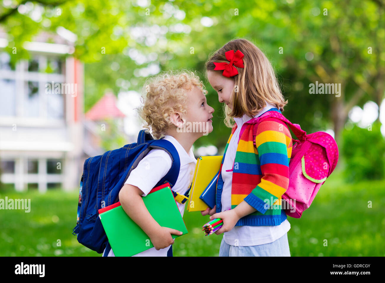 Child going to school. Boy and girl holding books and pencils on first ...