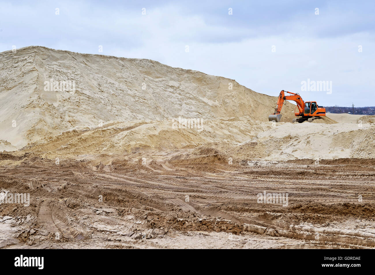 Working digger in a quarry produces sand Stock Photo - Alamy