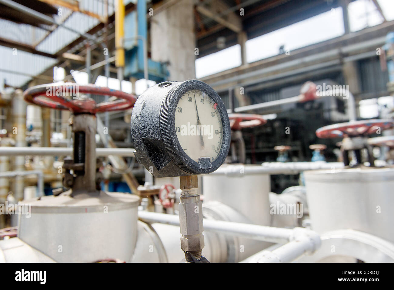 Pressure meter in natural gas processing plant in bright sunny summer ...