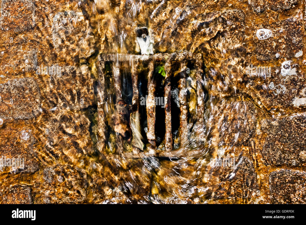Water running into a sewer Stock Photo - Alamy
