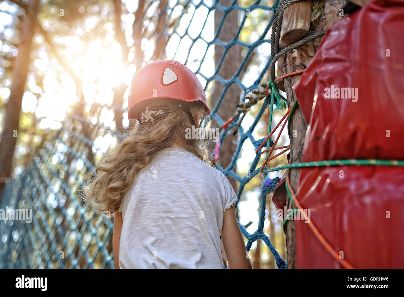 Young girl climbing on the rope park Stock Photo - Alamy