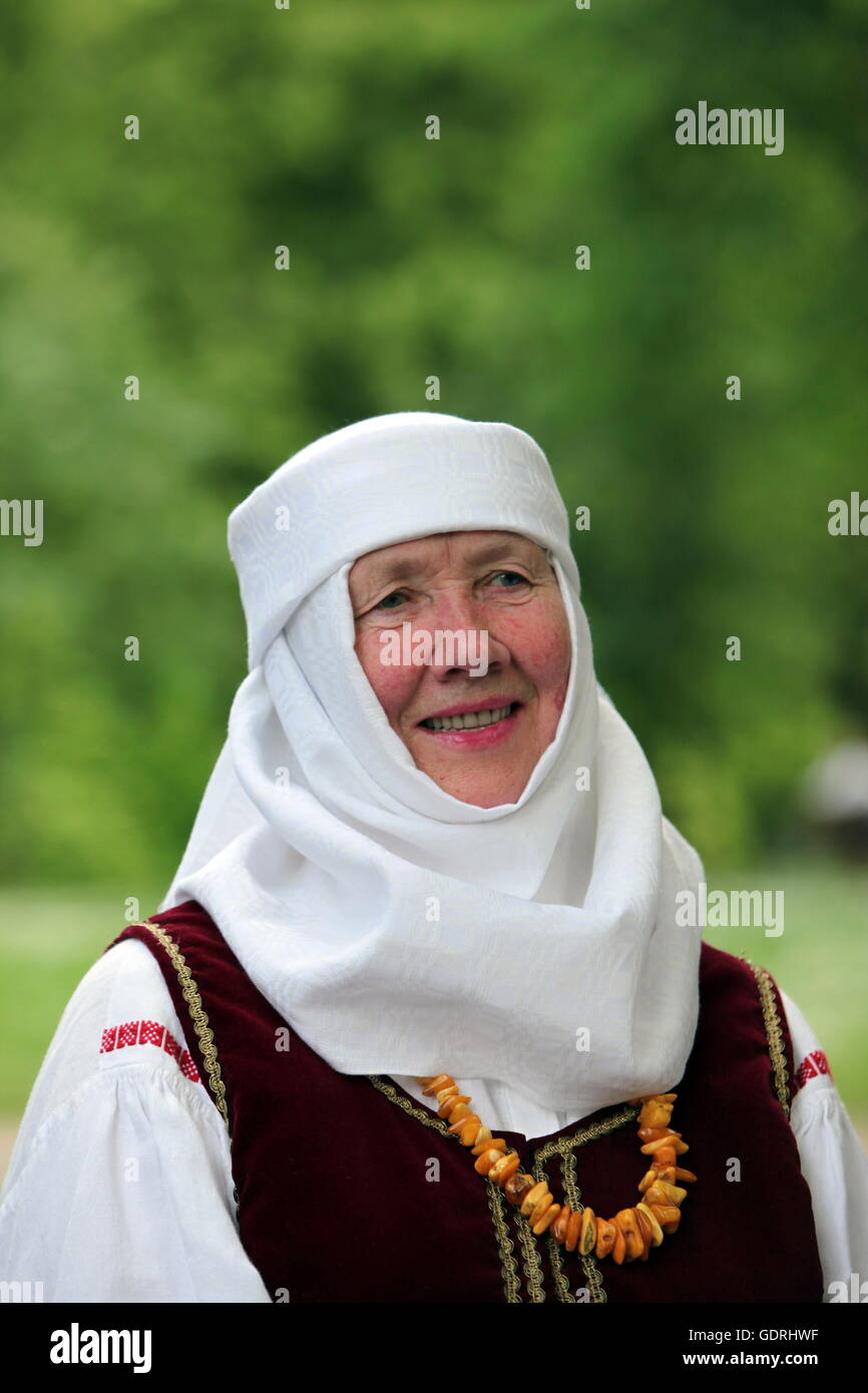 a Women in traditional dress on a Summer Festival in a Parc in the old ...