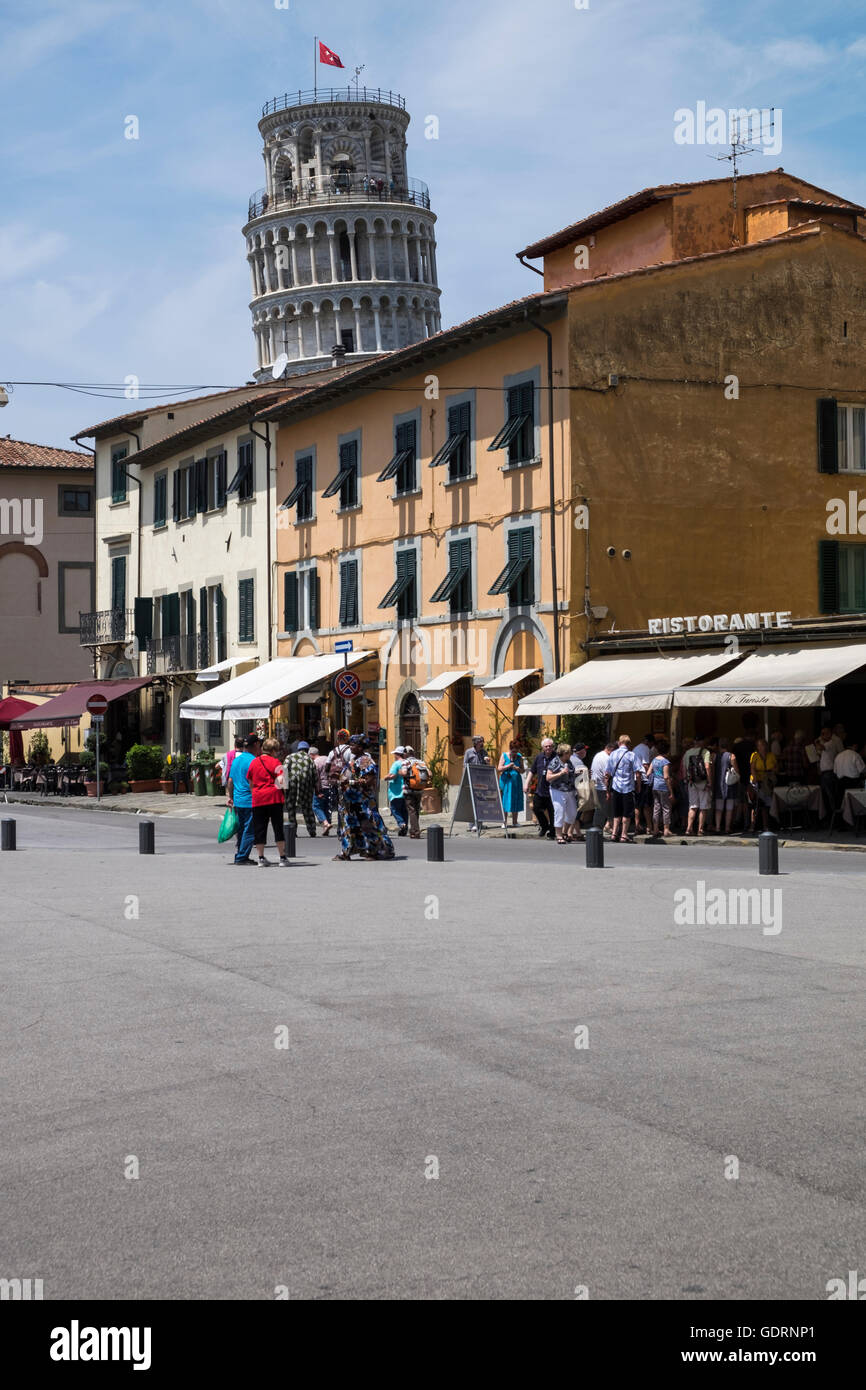 The leaning tower of Pisa towers over restaurants in the Piazza ...