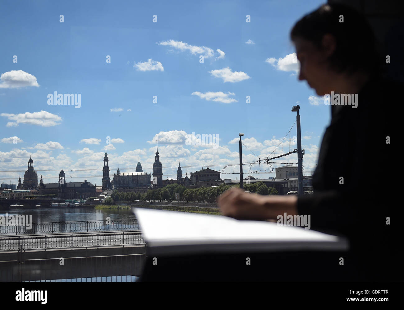 Artist Christine Wacker works on a drawing as she sits in the 'Kunstzug ...