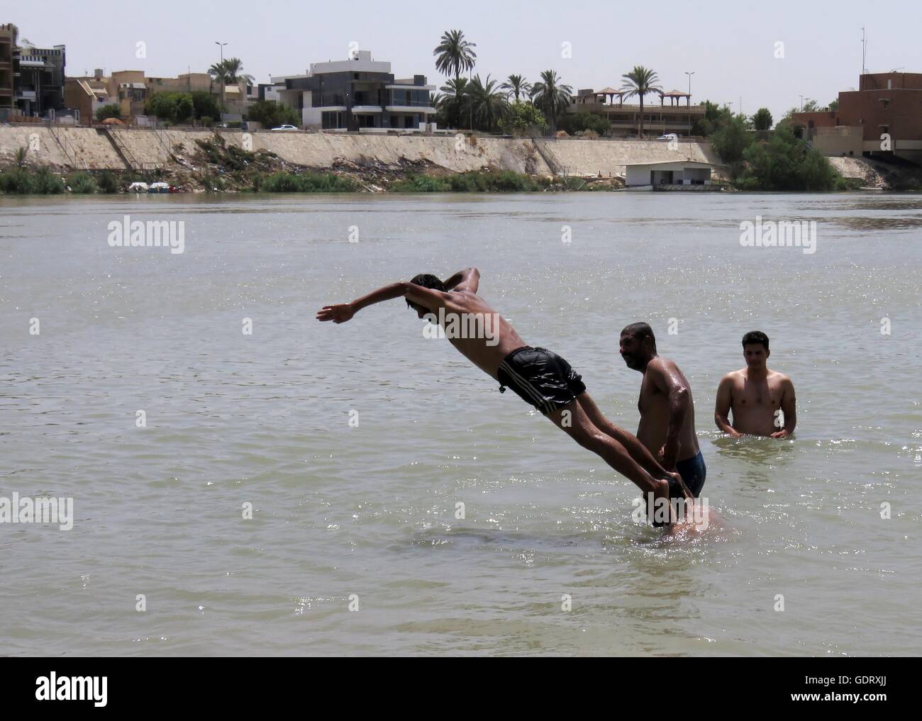 Baghdad, Iraq. 20th July, 2016. An Iraqi man jumps into Tigris river to ...