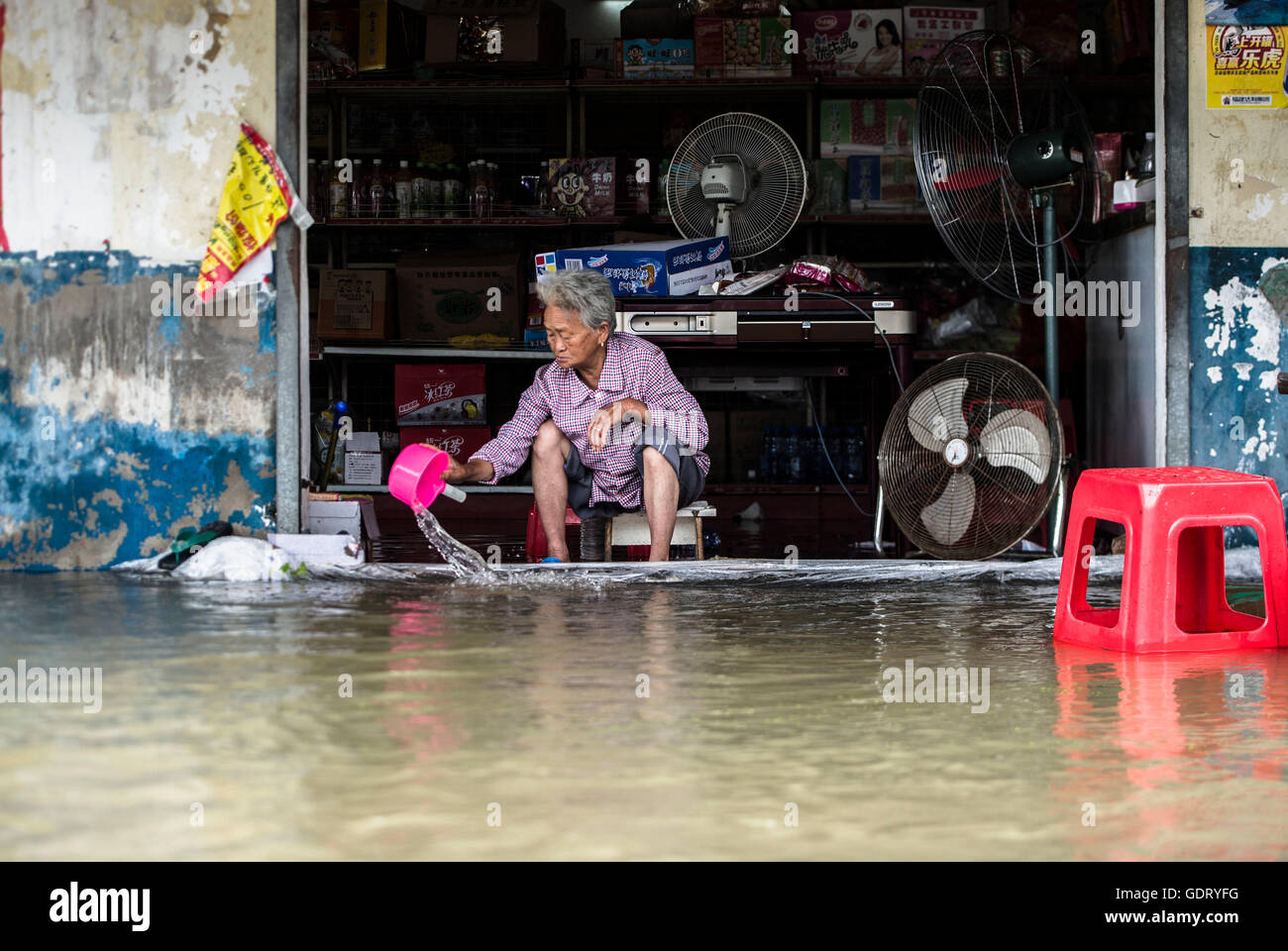 Shayang, China's Hubei Province. 20th July, 2016. A villager drains ...