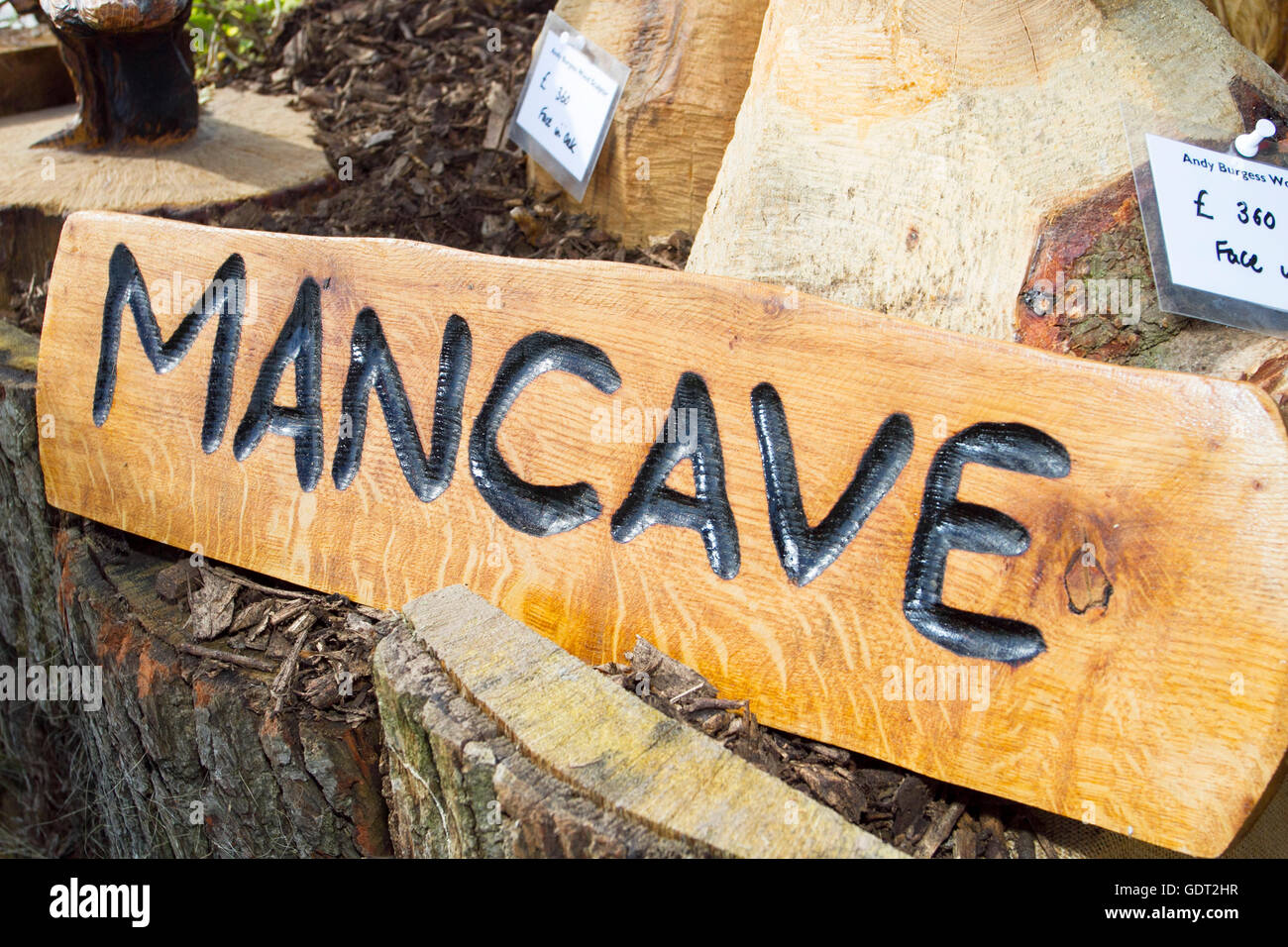 Tatton Park, Knutsford, UK. 21st July, 2016. Wooden carved Mancave sign ...