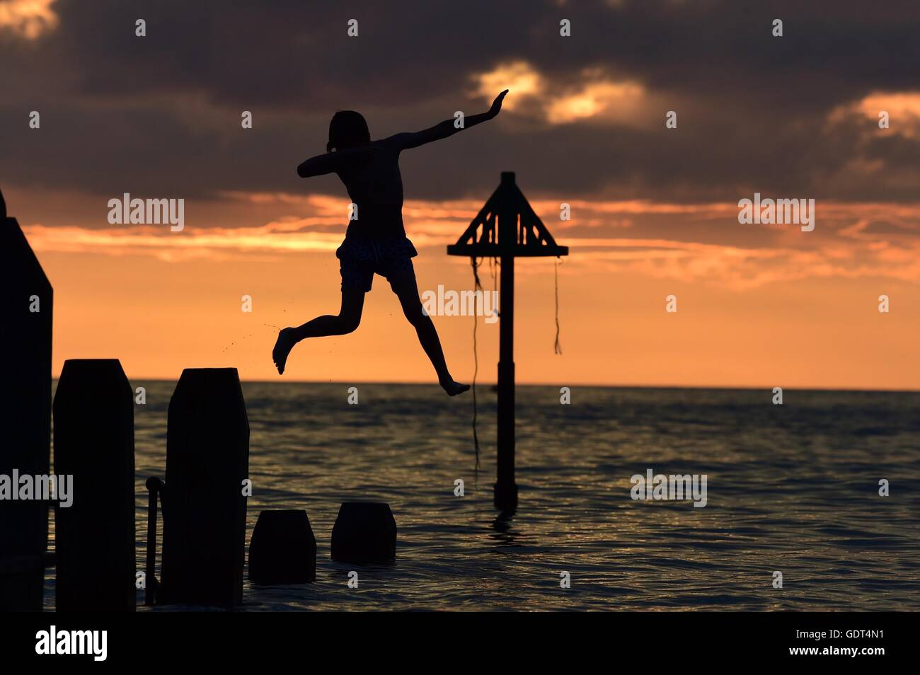Boy jumping off pier hi-res stock photography and images - Alamy