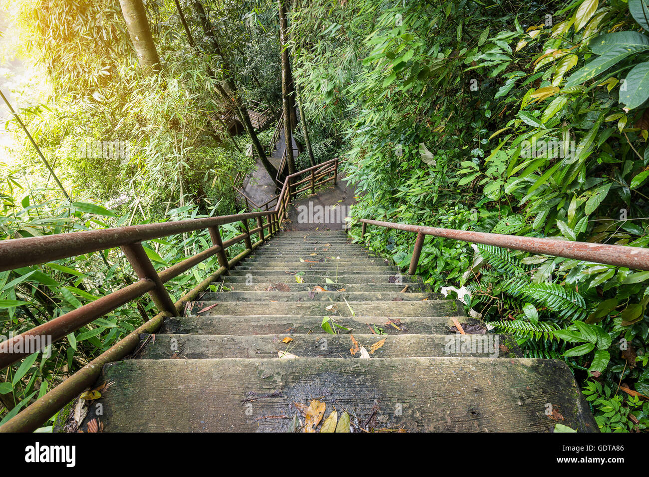 High and steep cement stairs with iron pipe wall getting down into ...